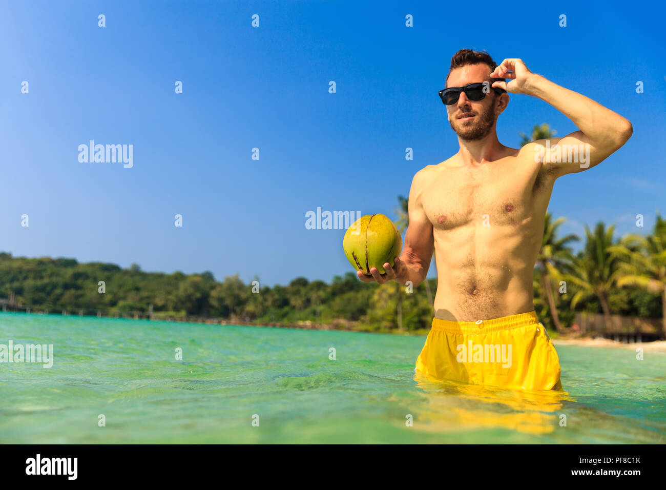Young men sunbathing beach hi-res stock photography and images - Alamy