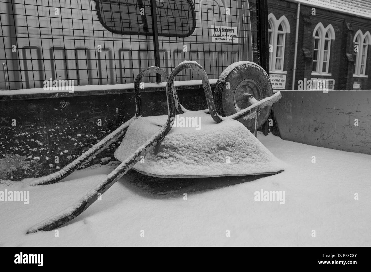 Wheelbarrow in snow Stock Photo - Alamy