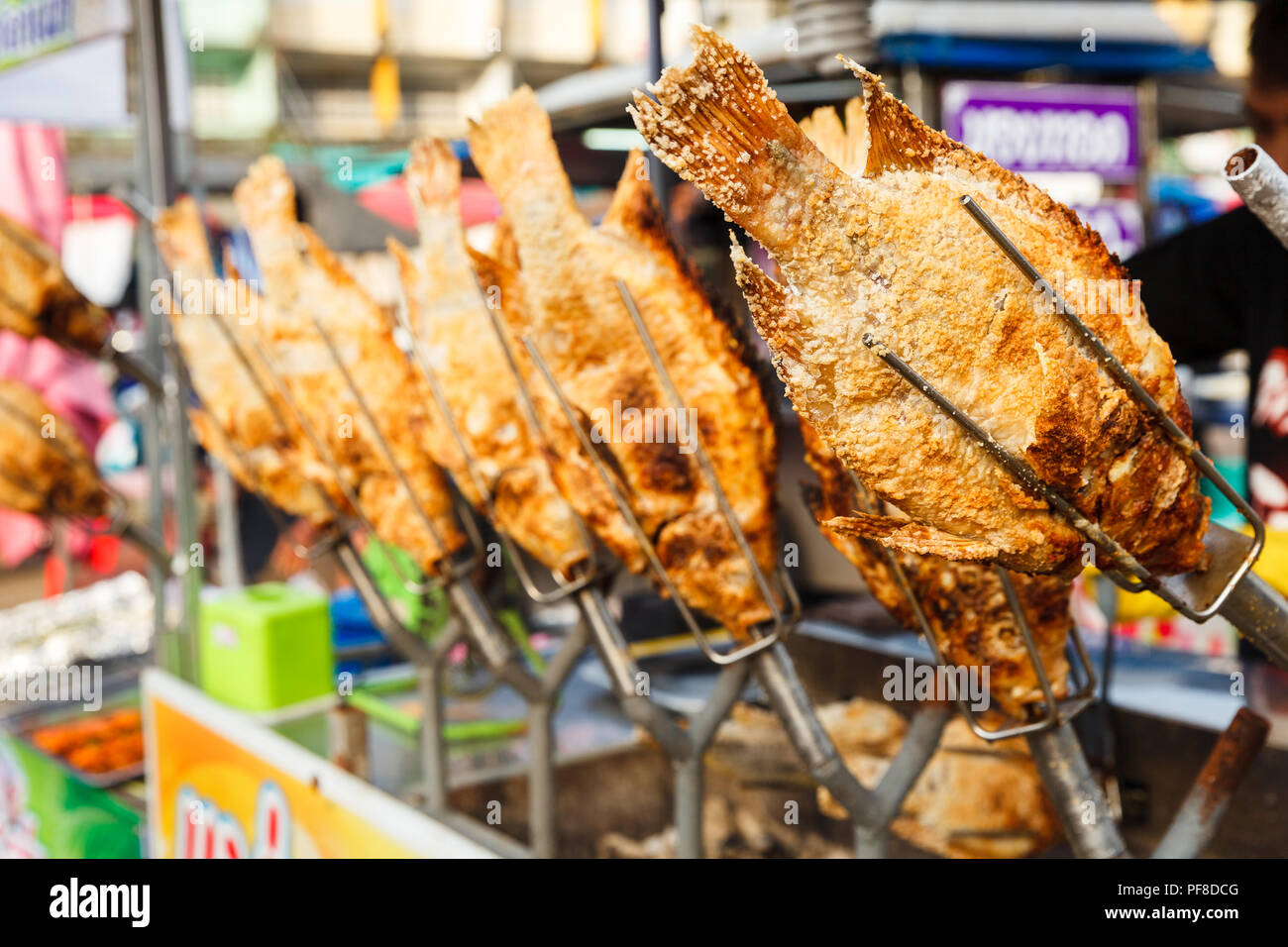 FoodTravel: grilled fish on the bbq grill in outdoor street market in ...