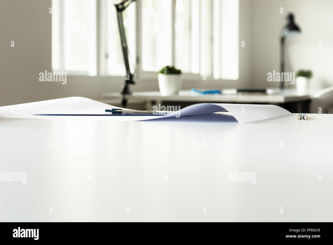Architects office in a low angle view across the table with foreground ...