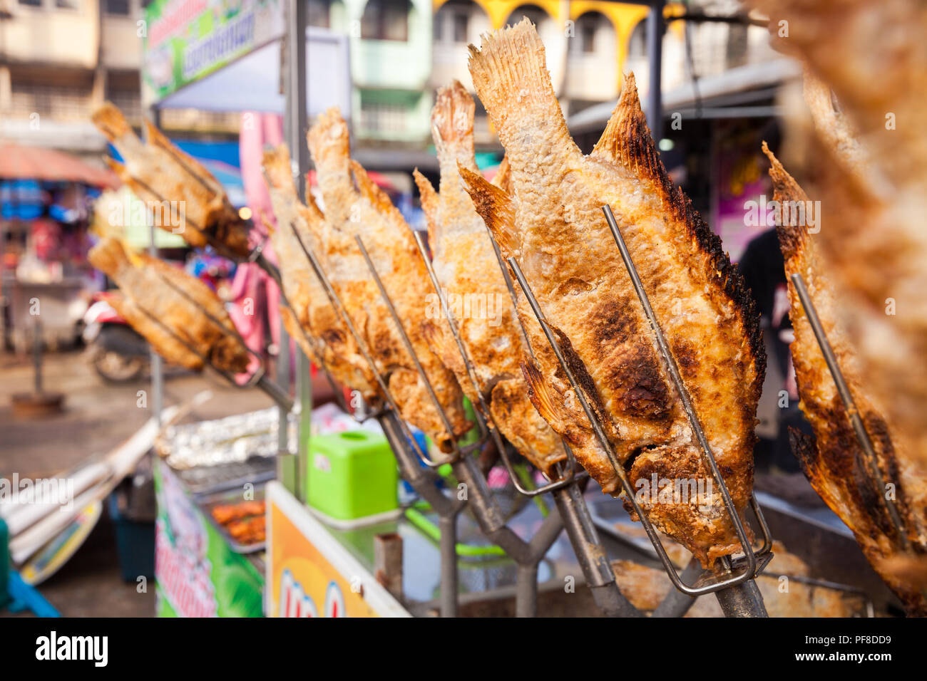 FoodTravel: grilled fish on the bbq grill in outdoor street market in ...