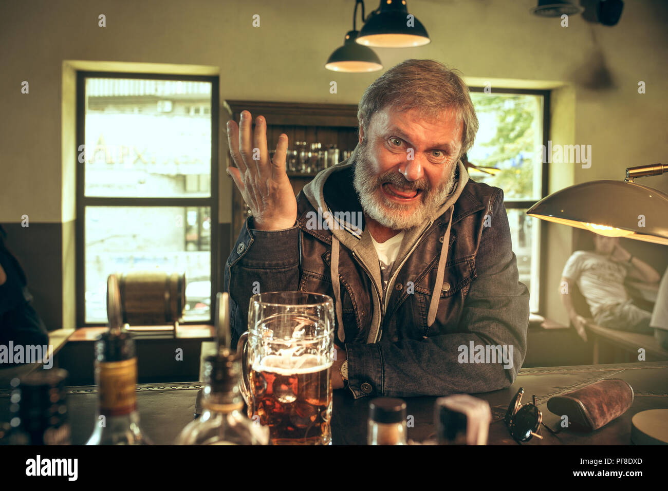 Angry man watching tv on hi-res stock photography and images - Alamy