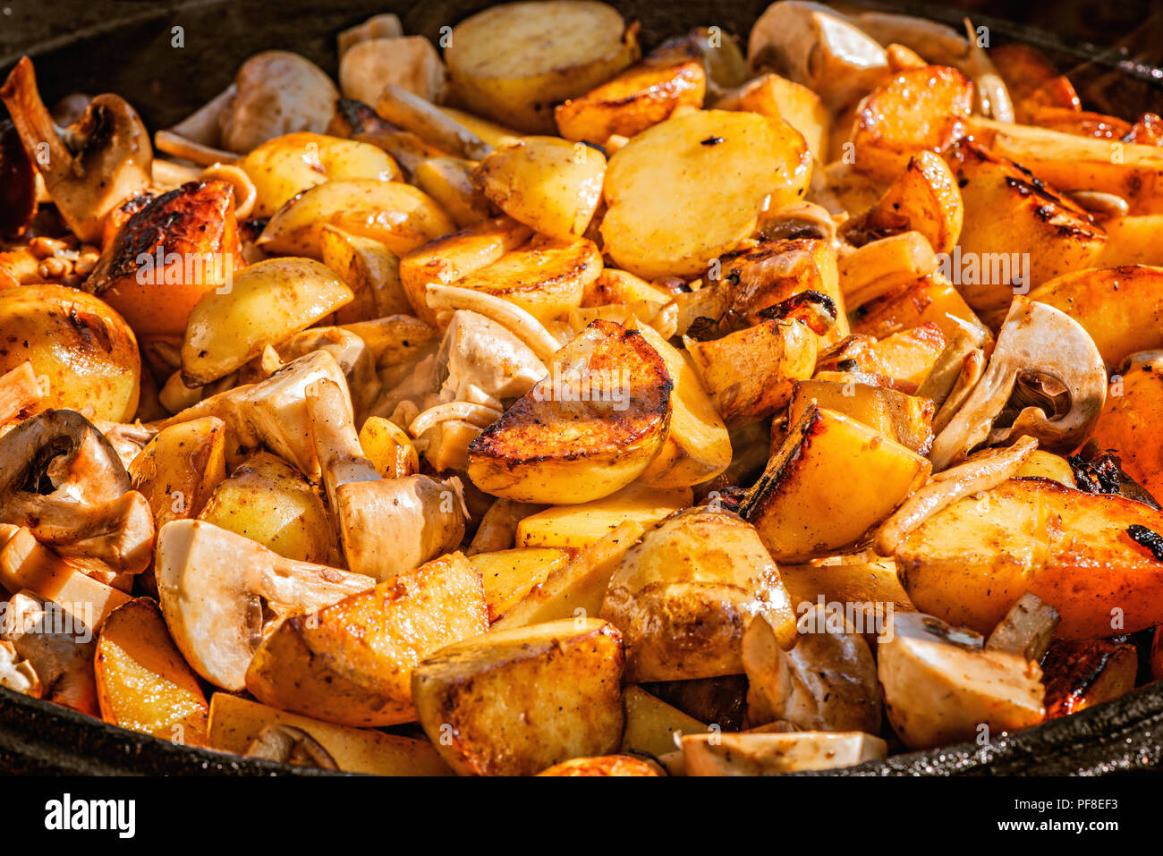 Cooking of potatos and mashrooms on the pan Stock Photo - Alamy