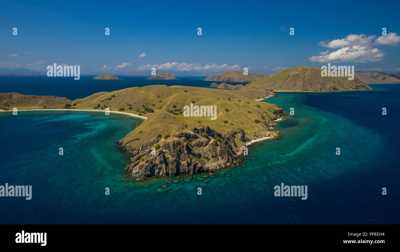 Drone photo of a rocky headland and coral reef at Gili Lawa Laut island ...