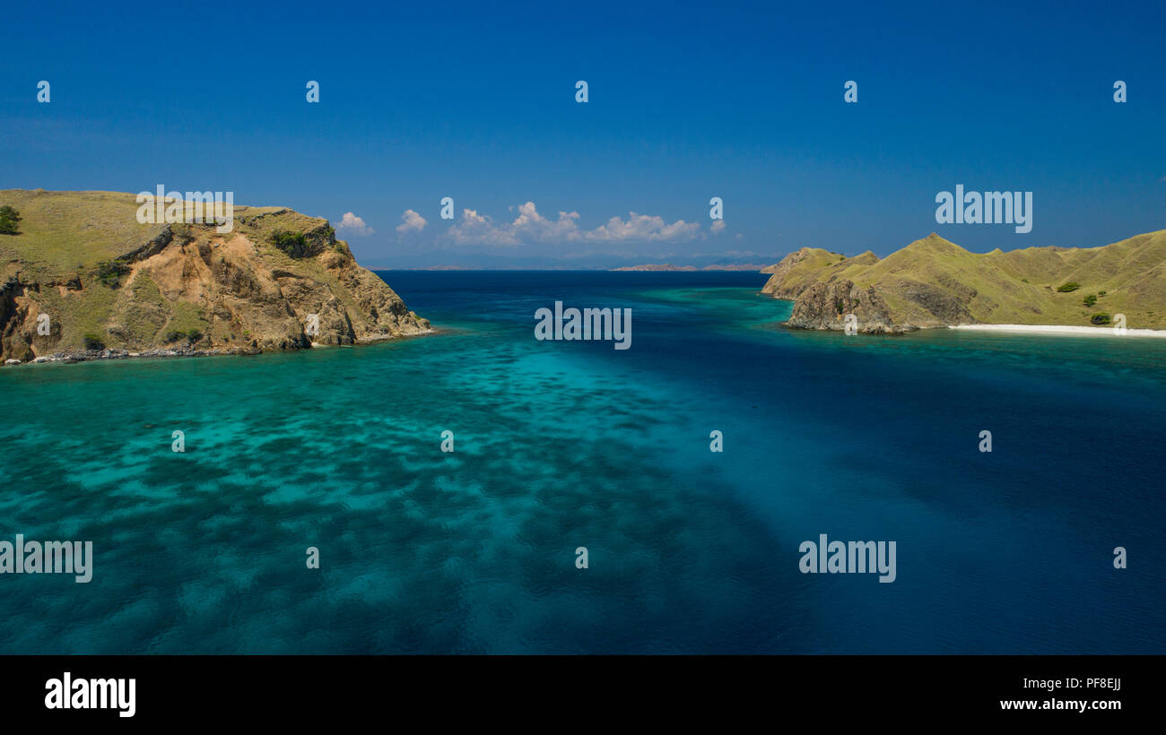 Drone photo of 2 headlands, narrow strait, blue water, shallow coral ...