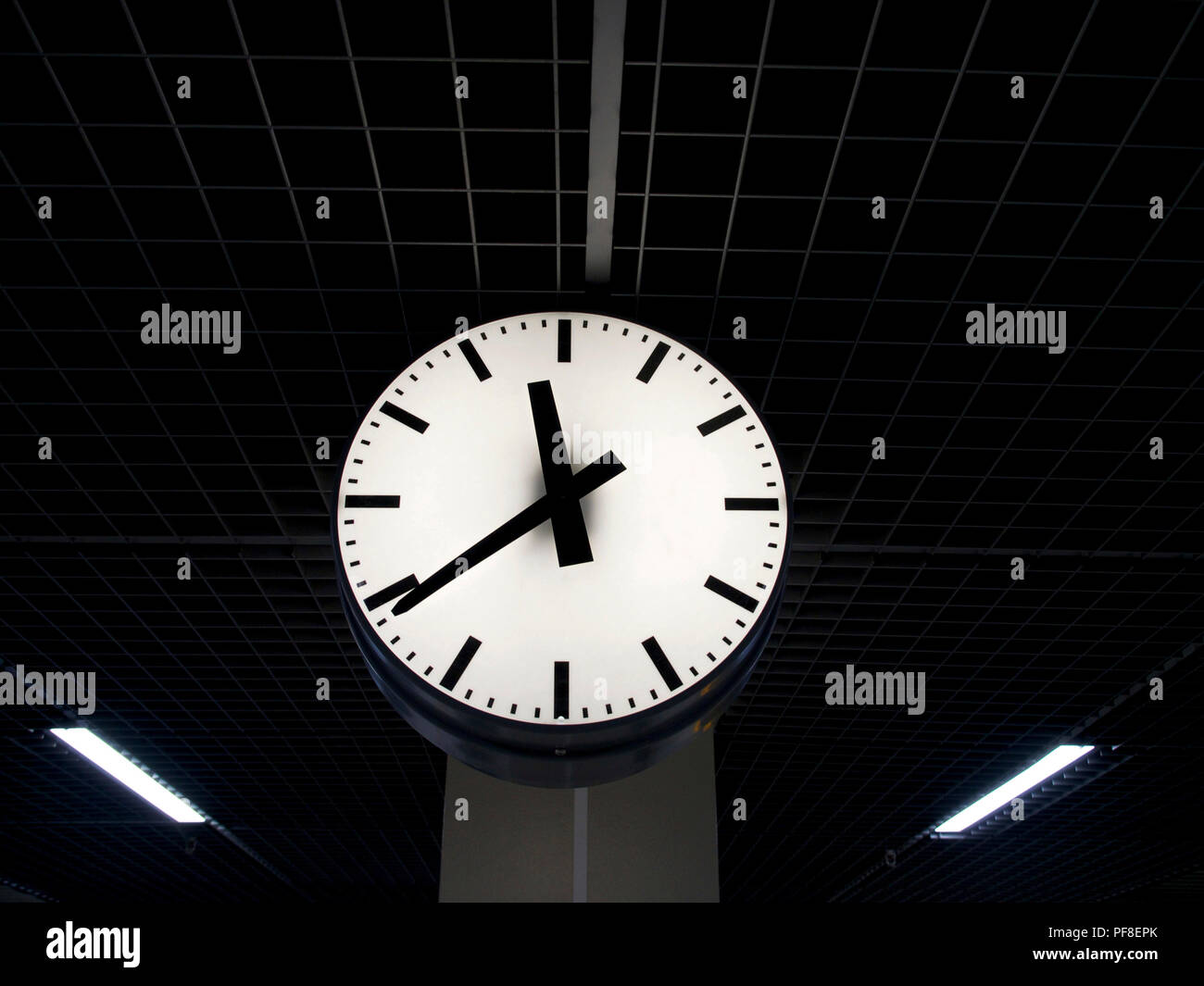 Closeup low angle shot of a white and black clock in a station Stock ...