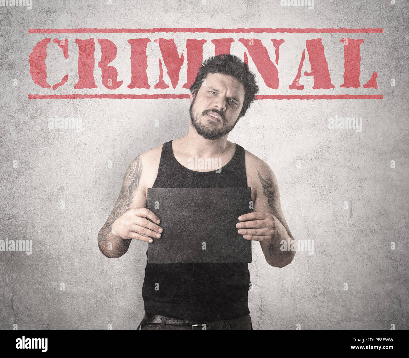 Caught gangster with criminal background Stock Photo - Alamy