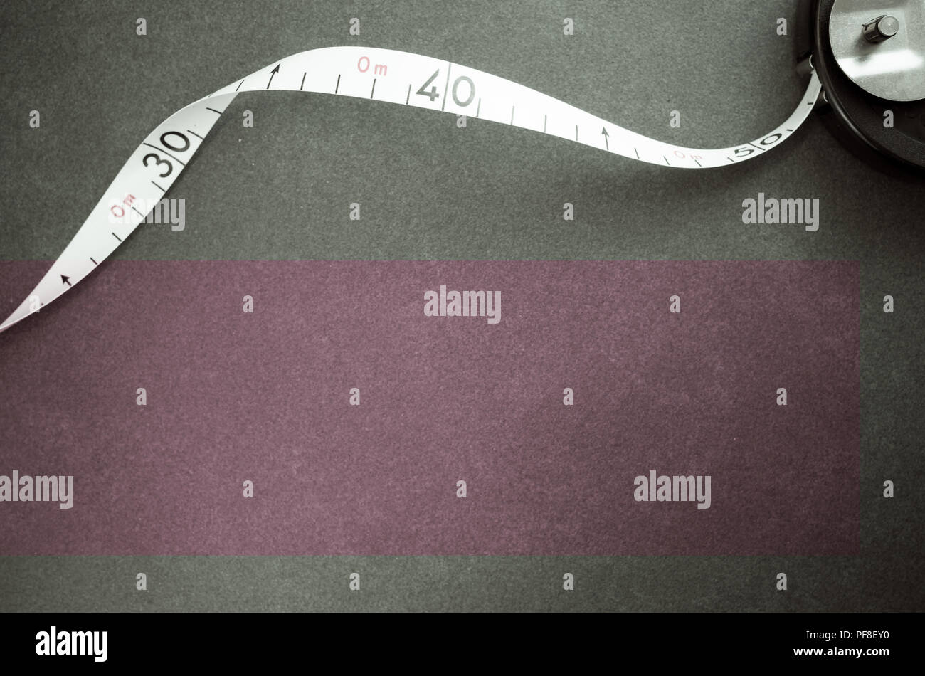 industrial metric measuring tape on a dark worktop surface - top view ...