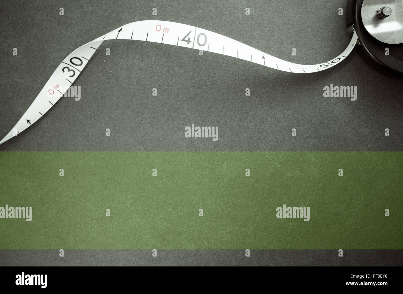 industrial metric measuring tape on a dark worktop surface - top view ...