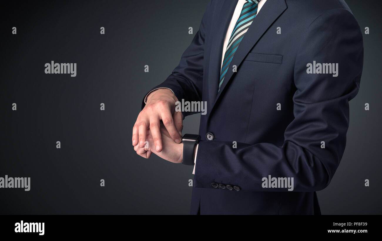 Man wearing suit with smartwatch on his wrist Stock Photo - Alamy