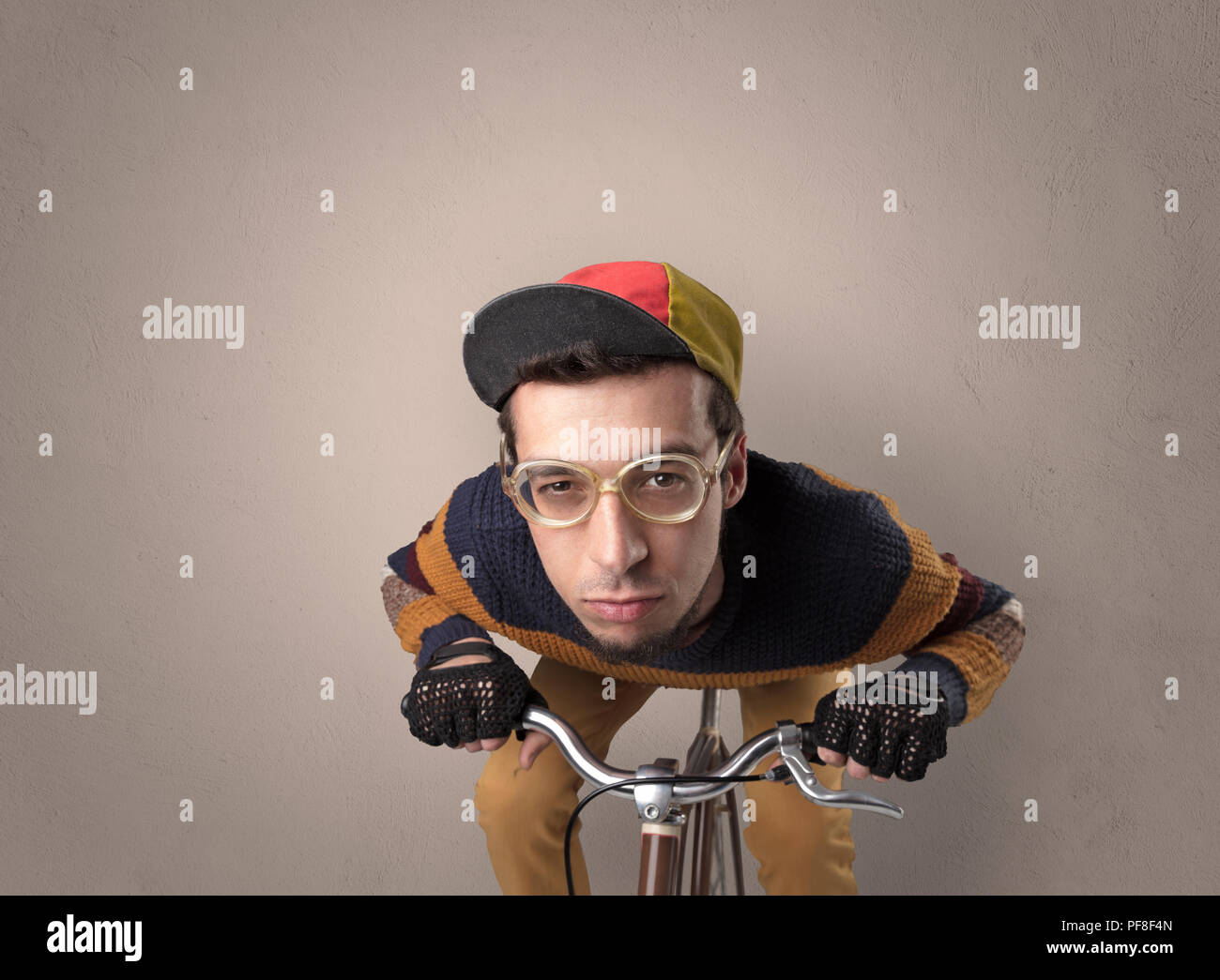 Nerd young foolish biker on a bike with oldschool outfit Stock Photo ...