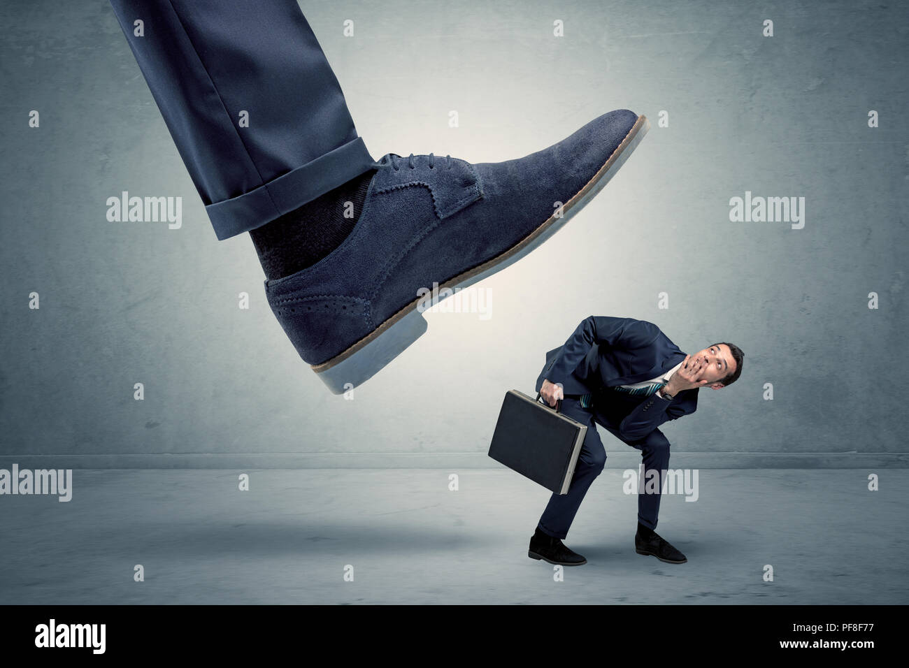 Demoralised employee symbolized by small man getting trampled Stock ...