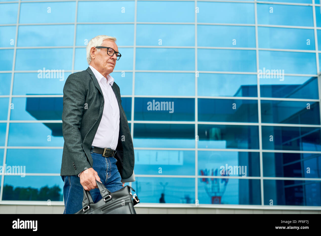 Senior businessman walking to work Stock Photo - Alamy