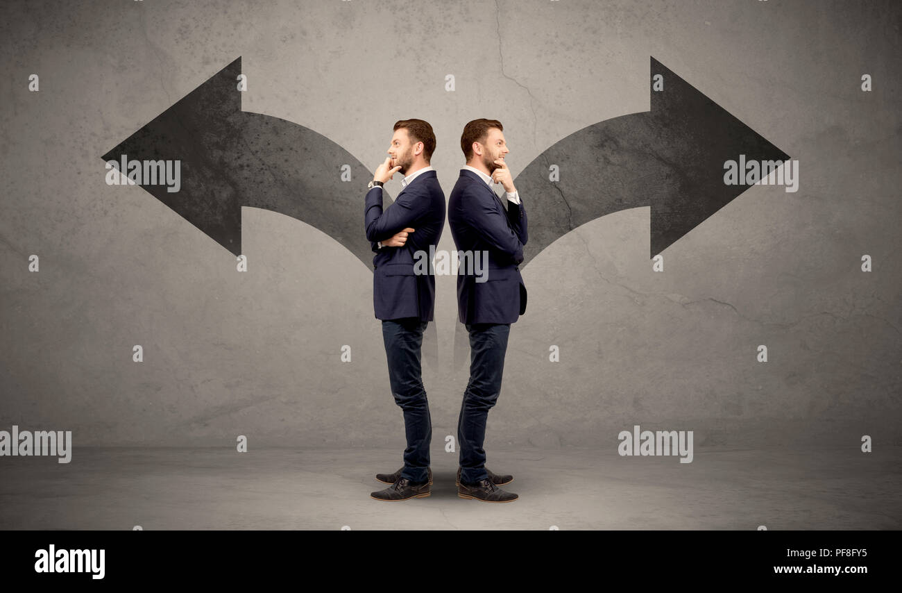 Young conflicted businessman choosing between two directions ...