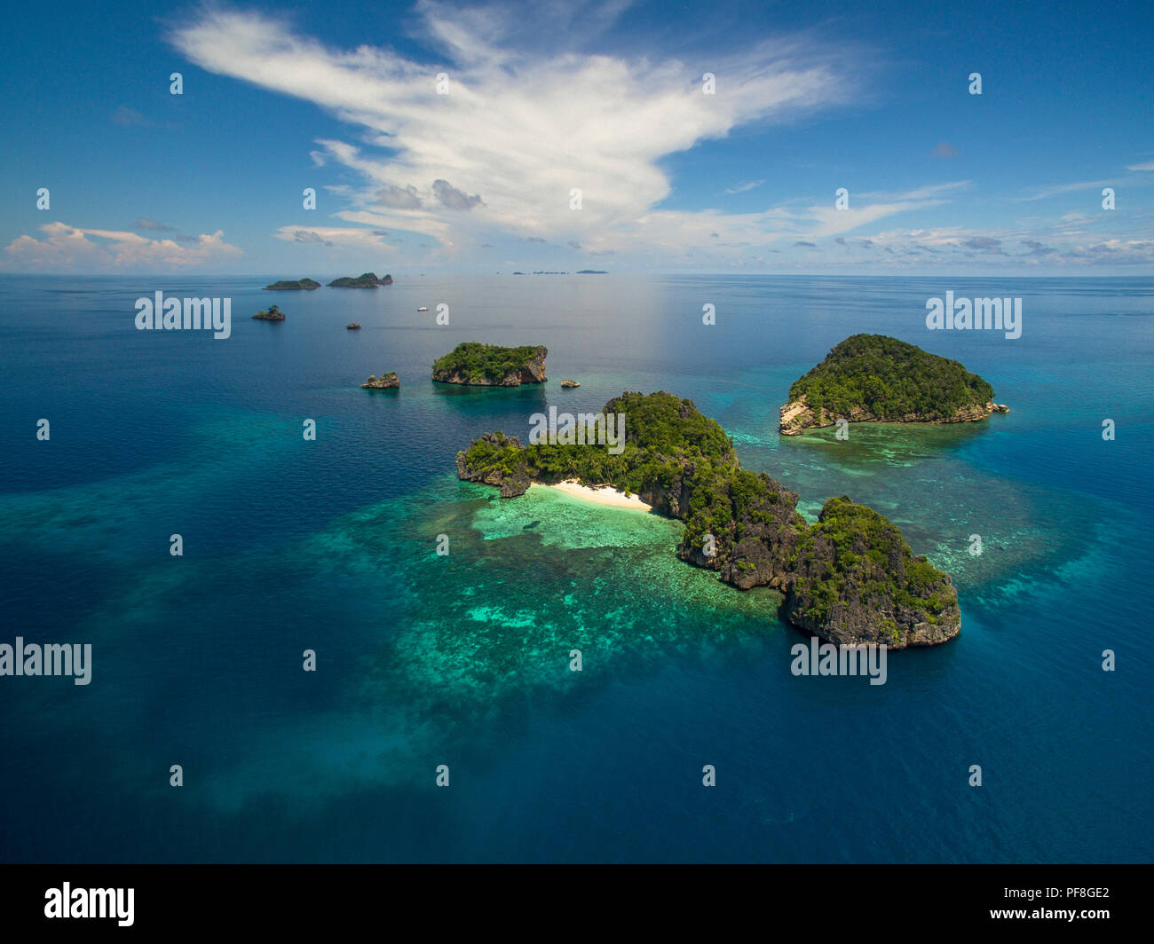 A drone photo of stunning, small tropical islands, ocean & coral reef ...
