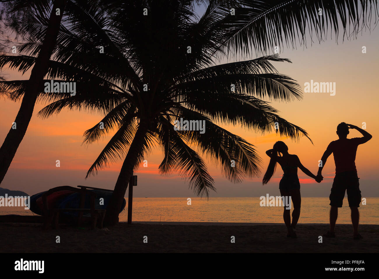 Silhouette loving couple tourist enjoy honeymoon vacation on tropical ...