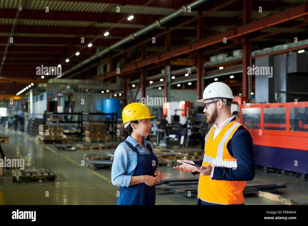 Foreman Instructing Worker at Plant Stock Photo - Alamy