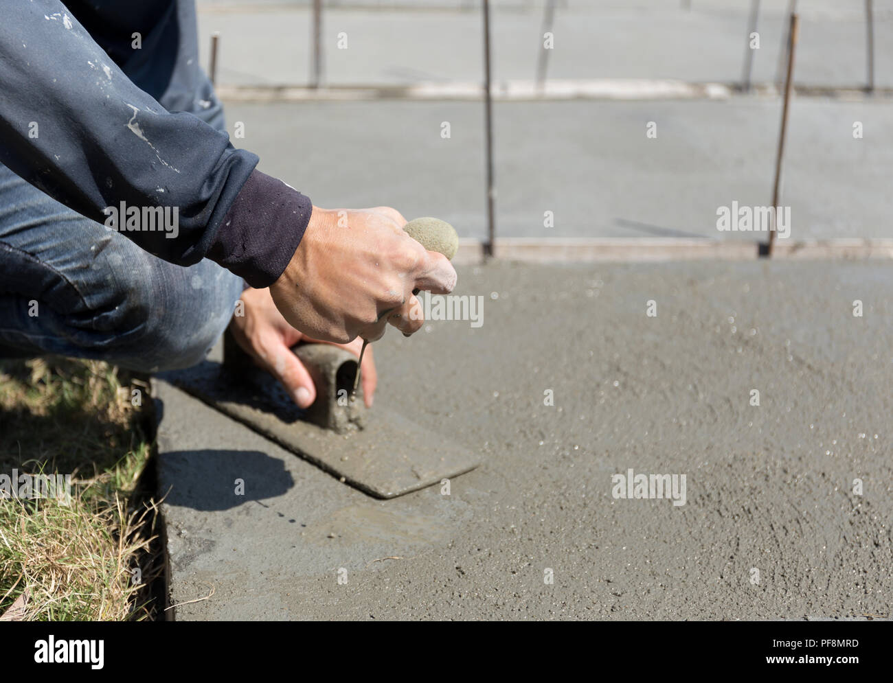 Worker smooth concrete floor squeeze sponge to wet the concrete Stock ...