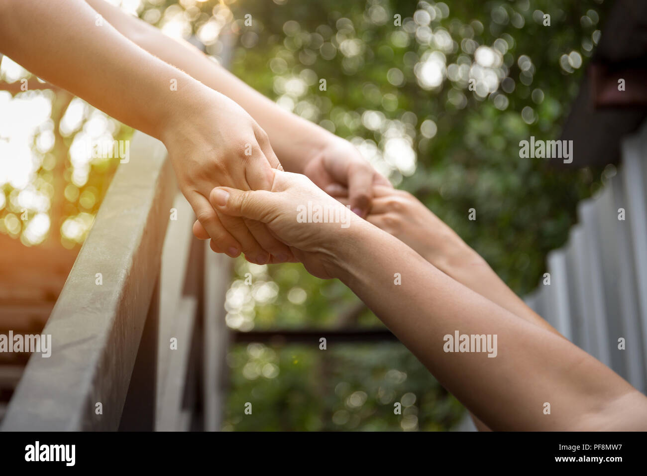 Help concept hand reaching out for help with light flare Stock Photo ...