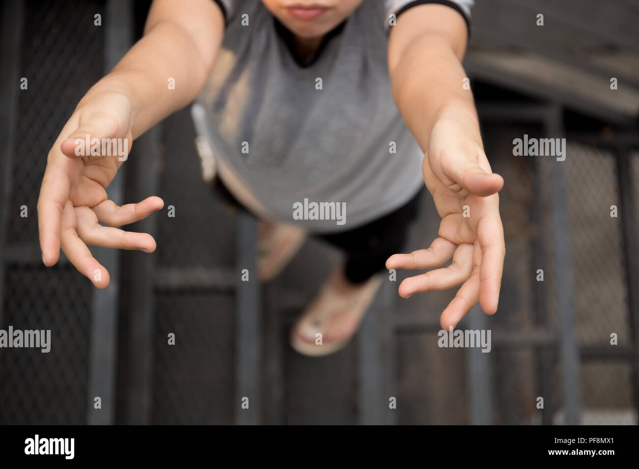 Help concept young woman hand reaching up Stock Photo - Alamy