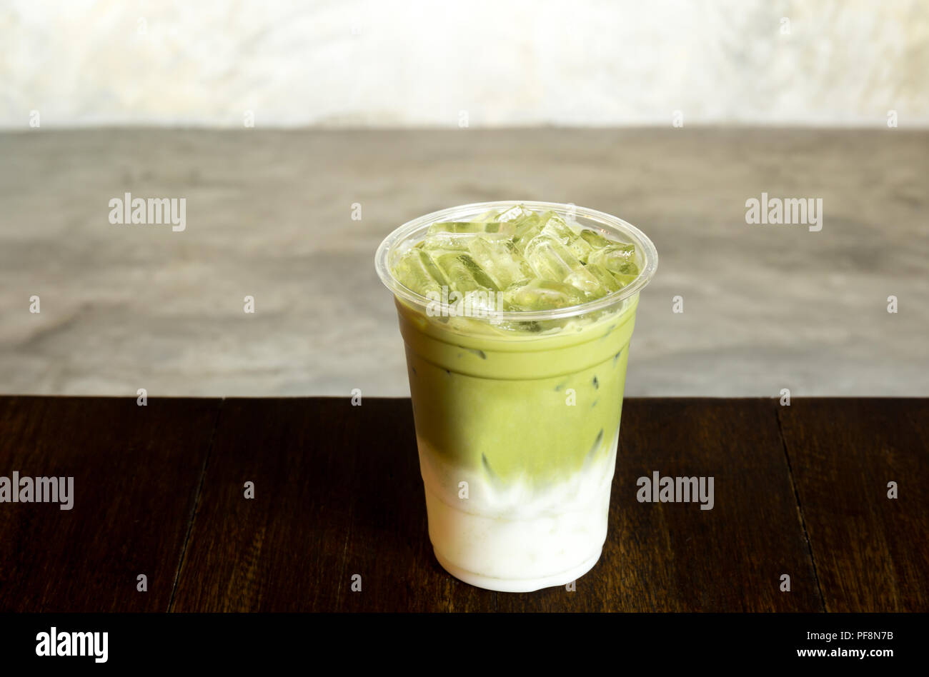 Iced matcha green tea latte in take away cup Stock Photo - Alamy
