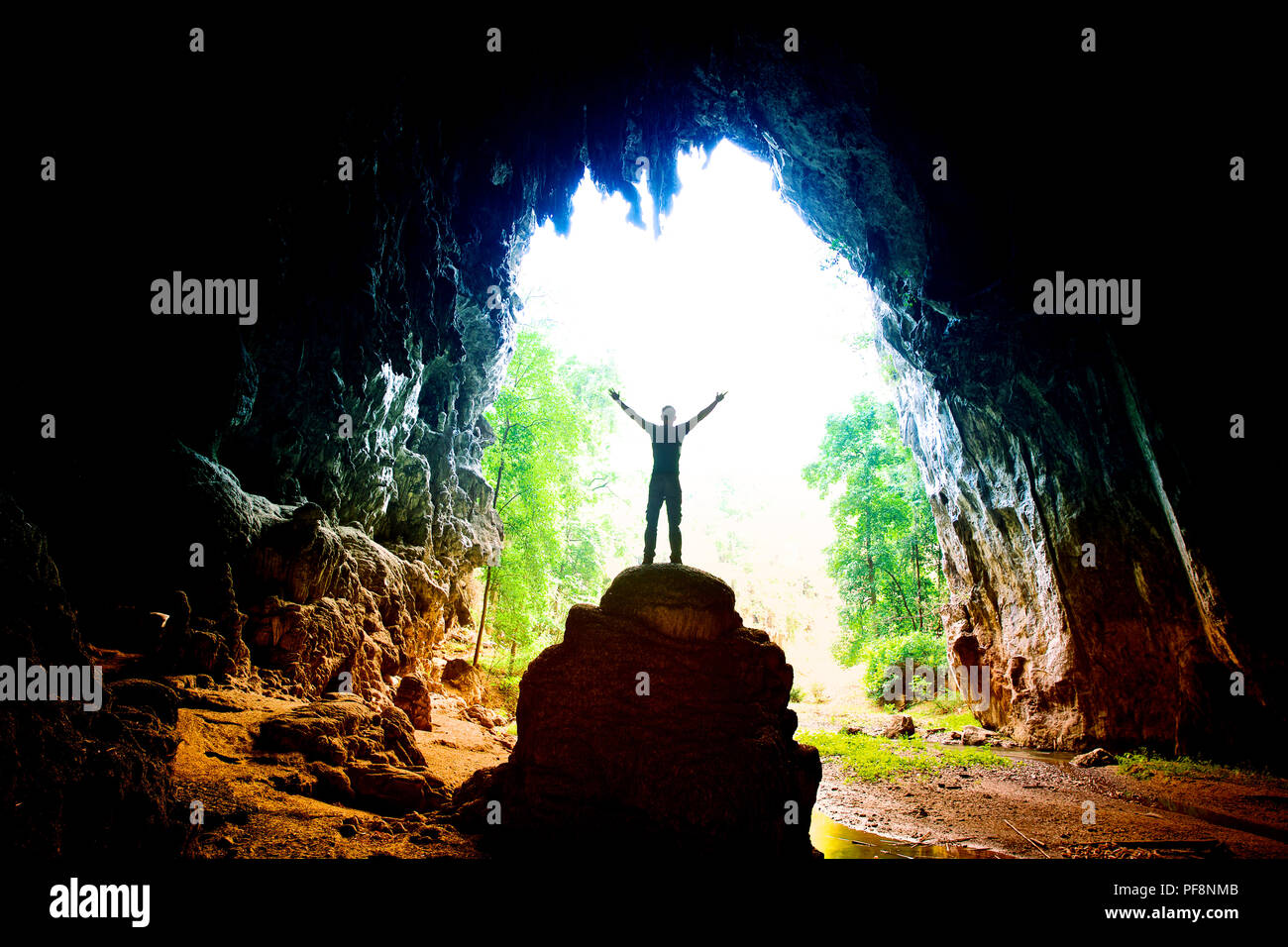 Happy successful tourist enjoy travel in mountain cave Stock Photo - Alamy