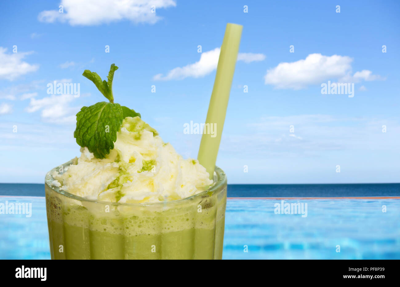 Glass of iced tea frappe drink by swimming pool Stock Photo - Alamy
