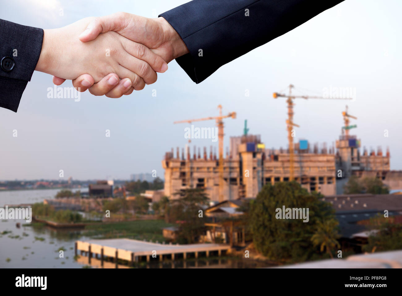 Businessman success hand shake agreement over building construc Stock ...