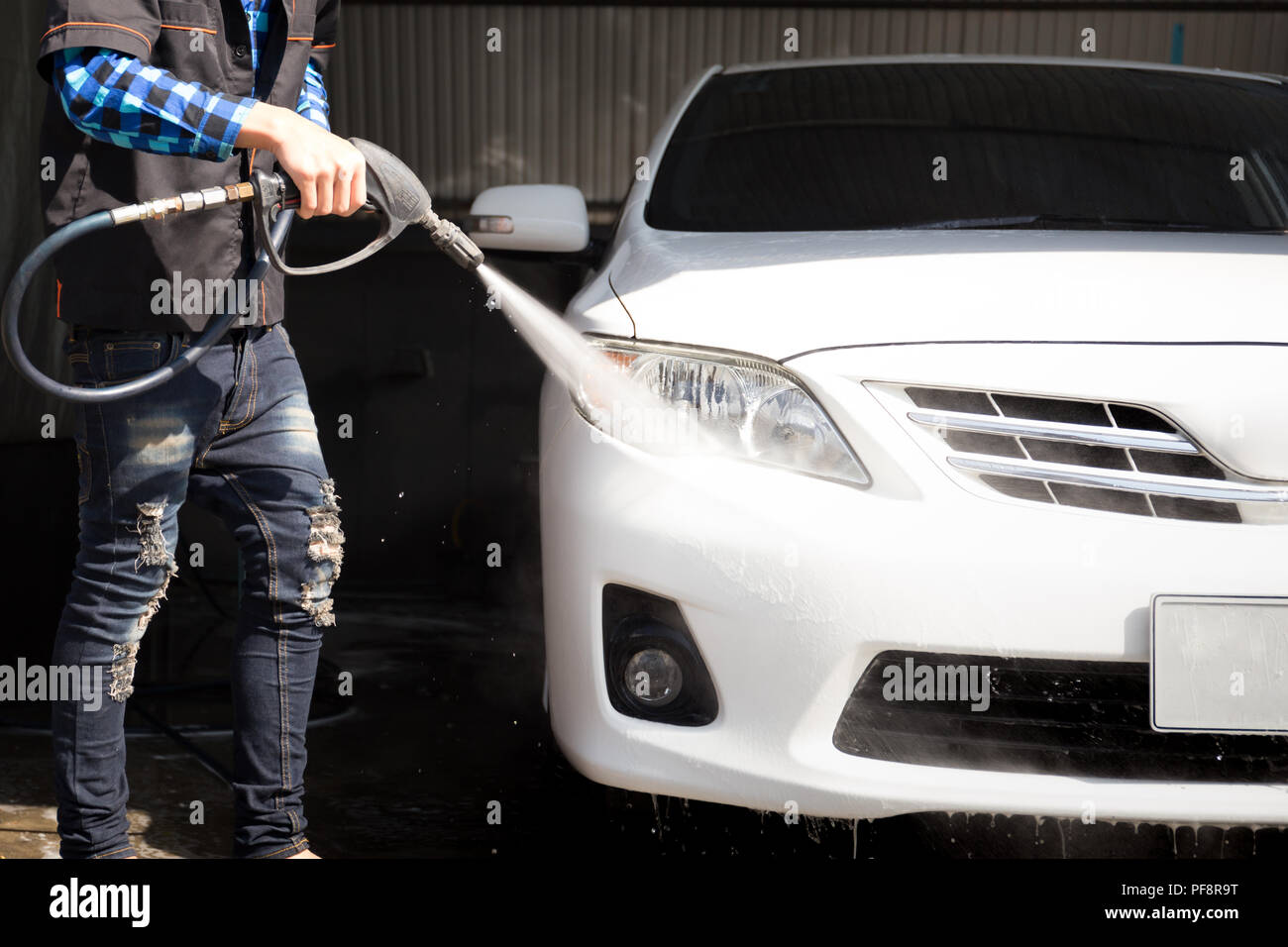 Man cleaning a car with high pressure jet pump Stock Photo - Alamy