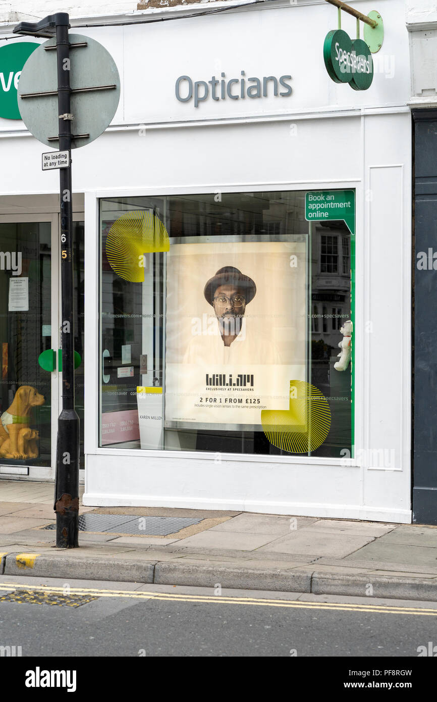 Specsavers opticians shop window with a picture of Will-I-Am Stock ...