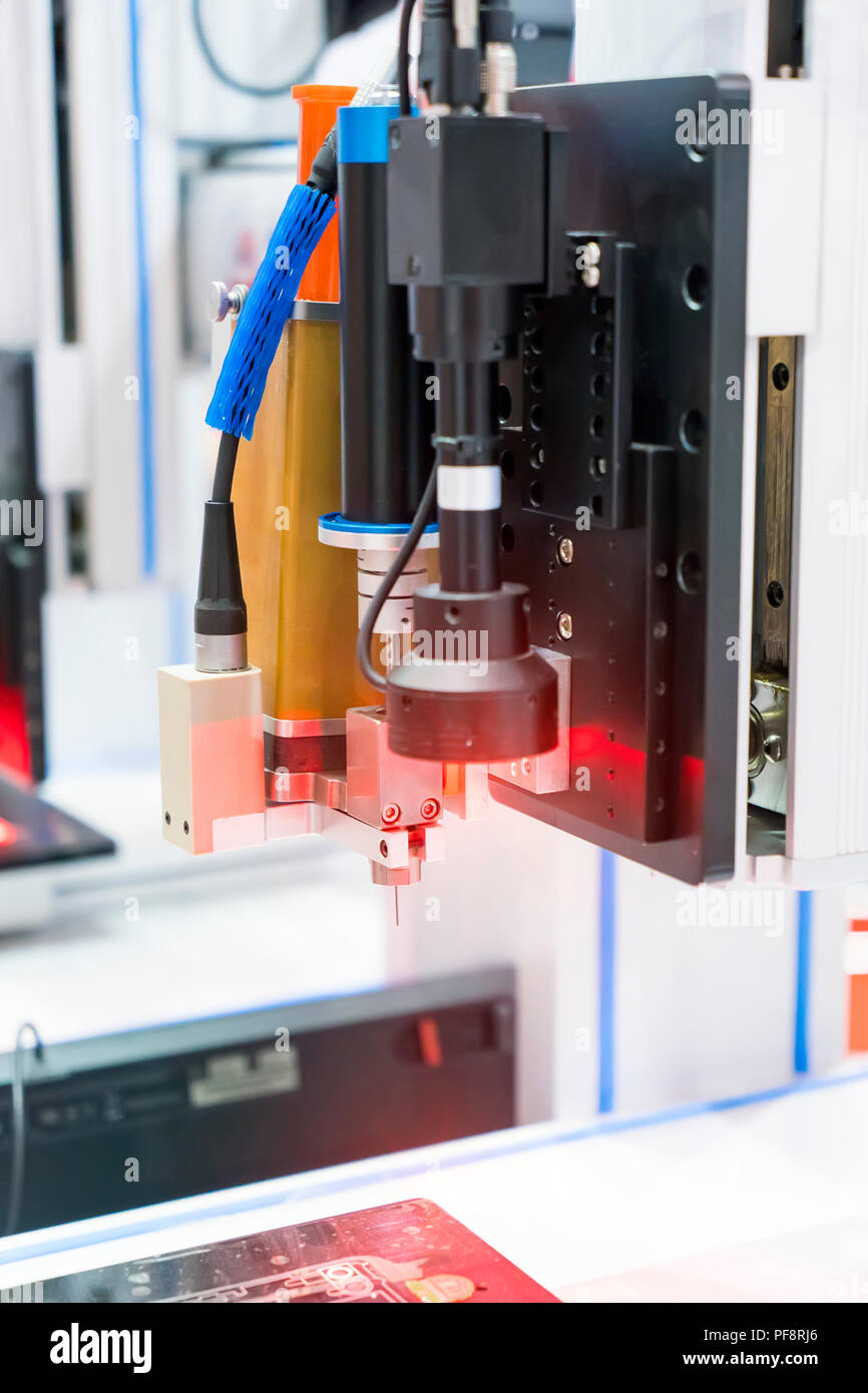 Robot holding glue syringe Injection with robotic machine vision system ...