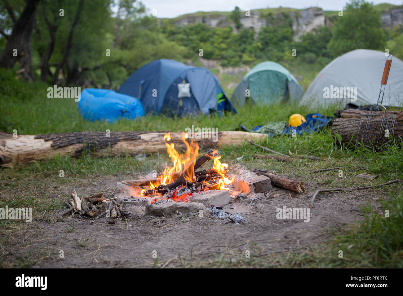 Photo of campground and campfire in forest Stock Photo - Alamy