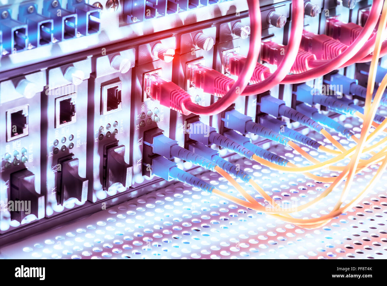Fiber Optic cables connected to an optic ports and Network cables ...
