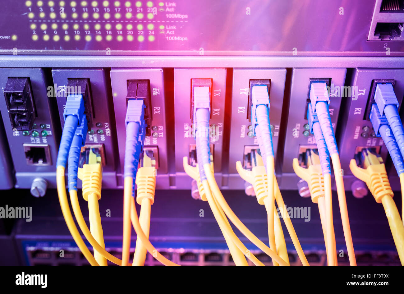 Fiber Optic cables connected to an optic ports and Network cables ...