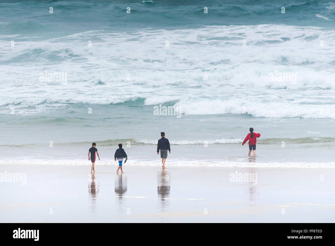 Children playing in the waves hi-res stock photography and images - Alamy