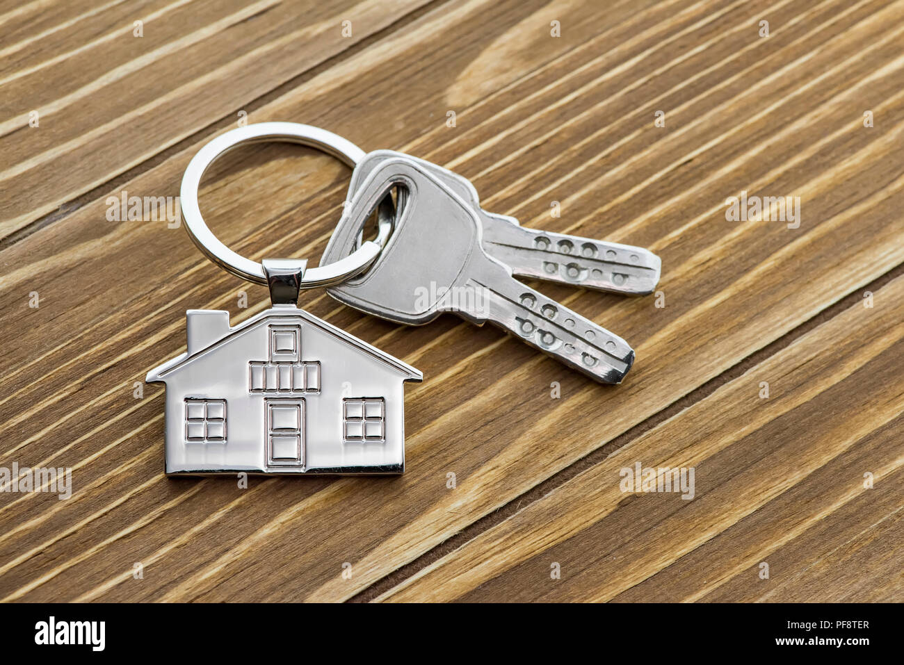 keychain with house symbol and keys on wooden background,Real estate ...
