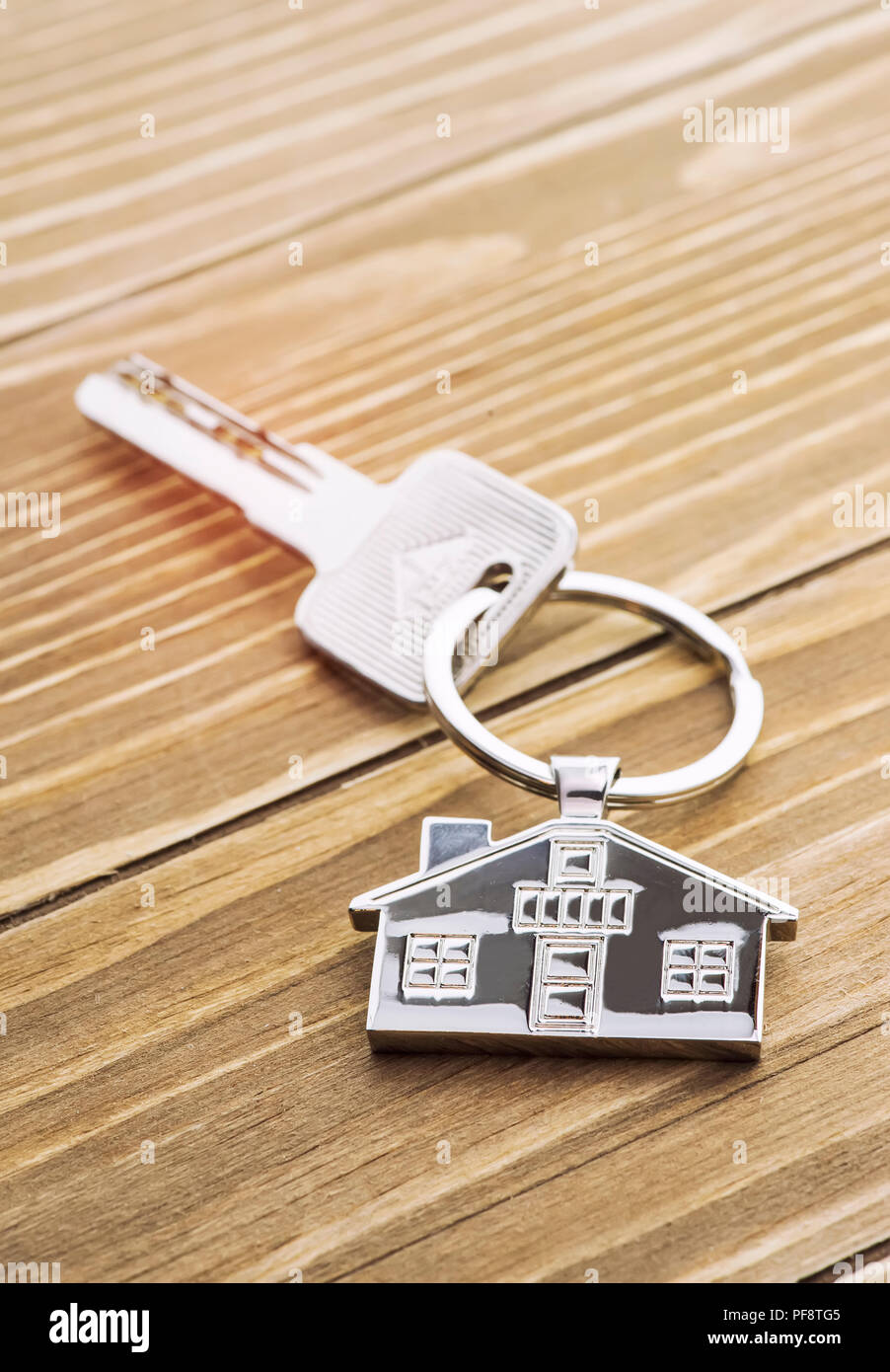 keychain with house symbol and keys on wooden background,Real estate ...