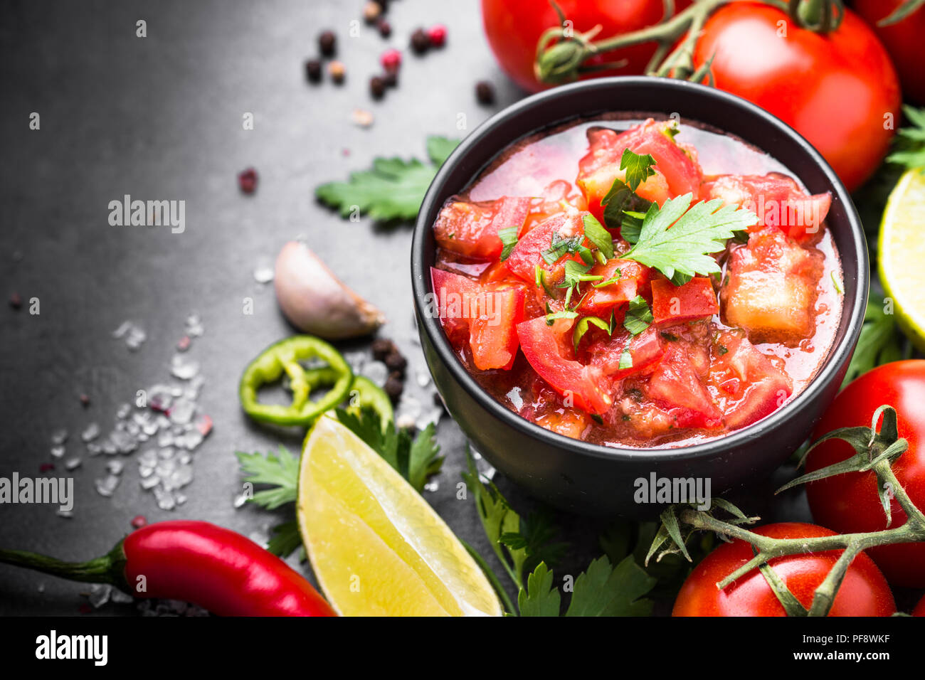 Traditional Latin American mexican salsa sauce and ingredients on black ...