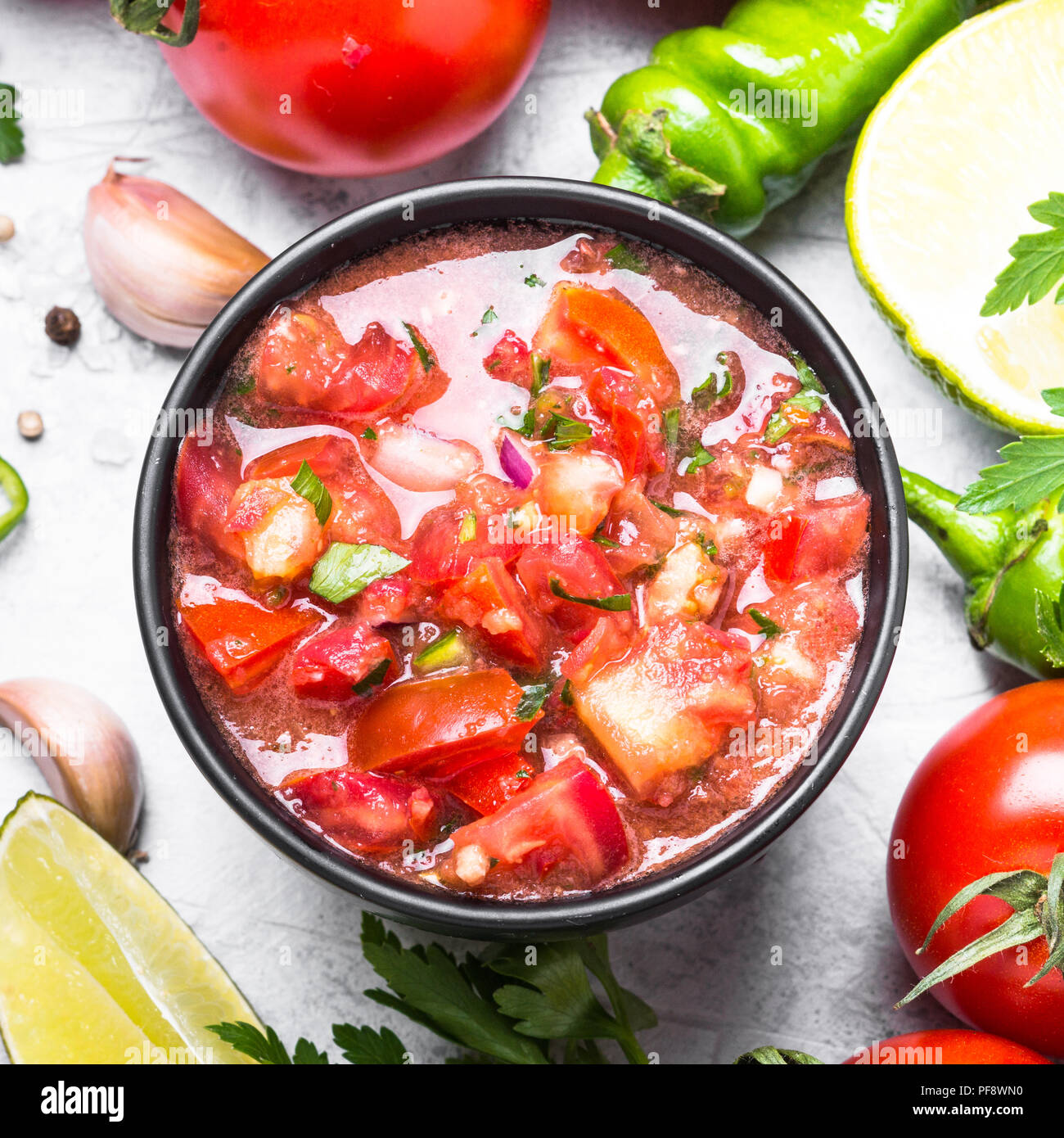 Traditional Latin American mexican salsa sauce and ingredients on stone ...