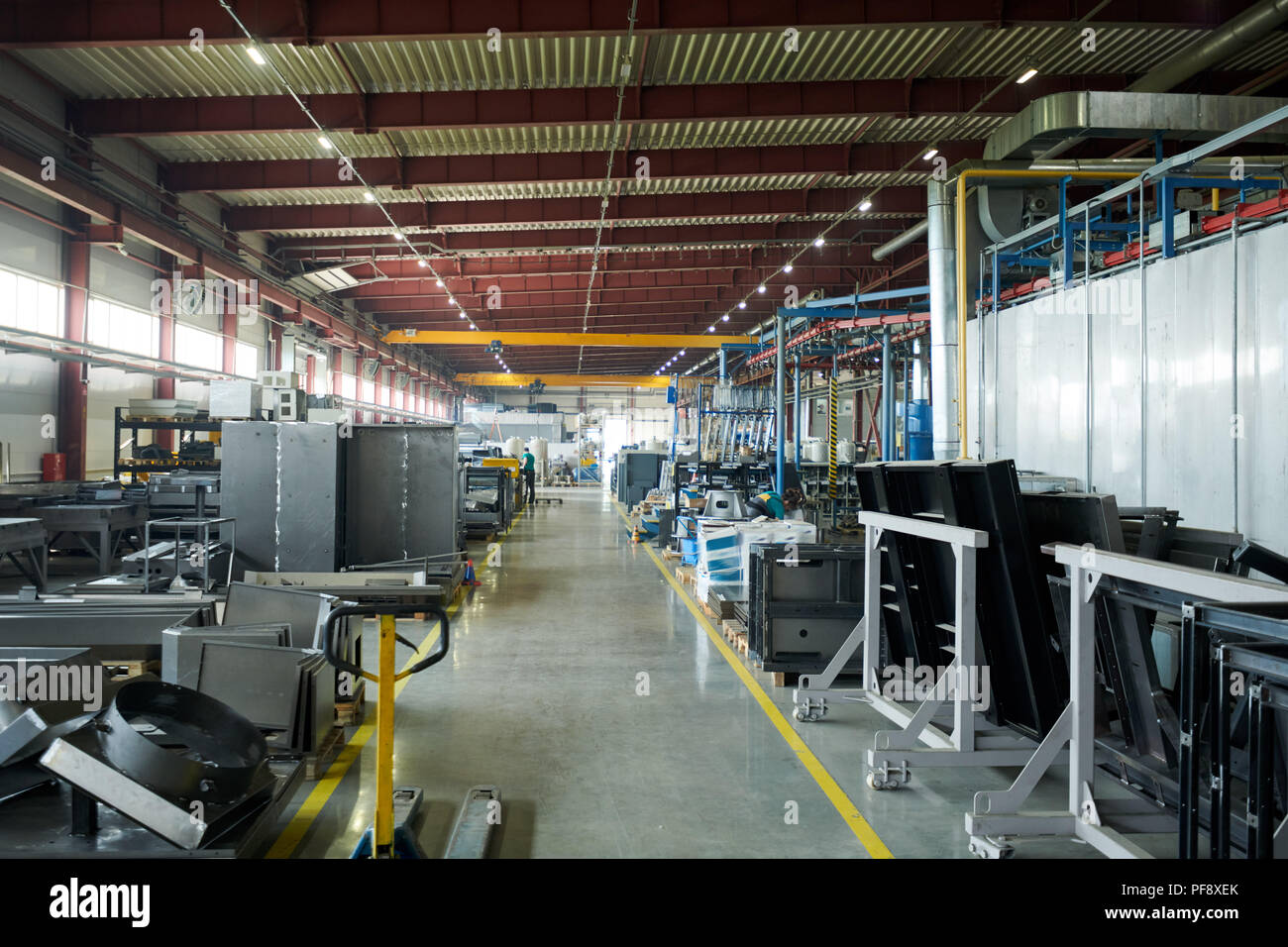 Wide angle shot of empty factory workshop with metal machine parts ...