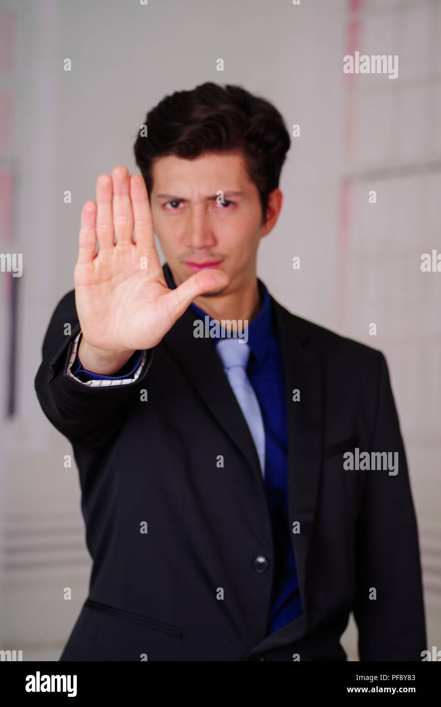 Close up of boss wearing a suit with his open hand pointing in front of ...