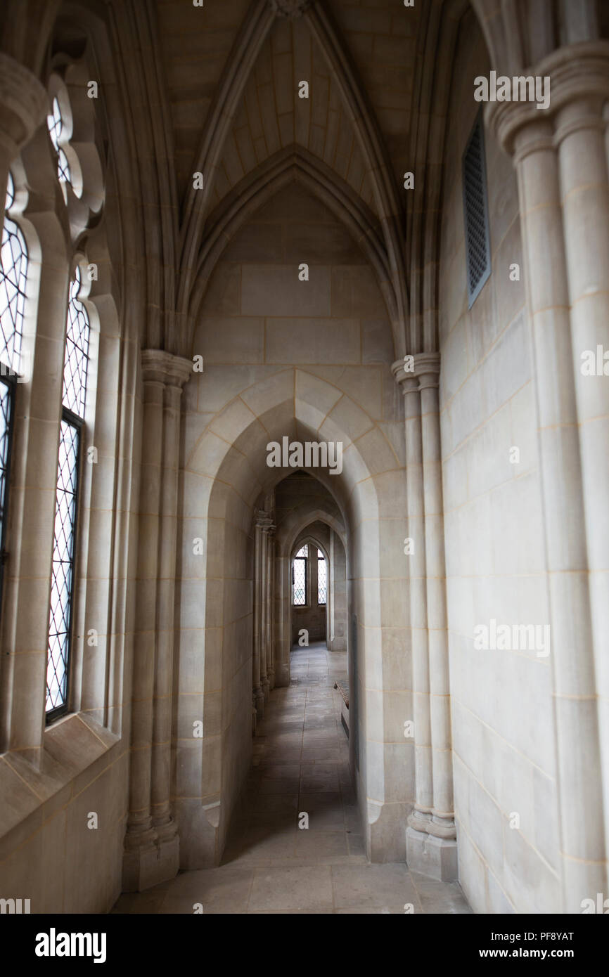 A stone walkway with arches inside the National Cathedral in Washington ...