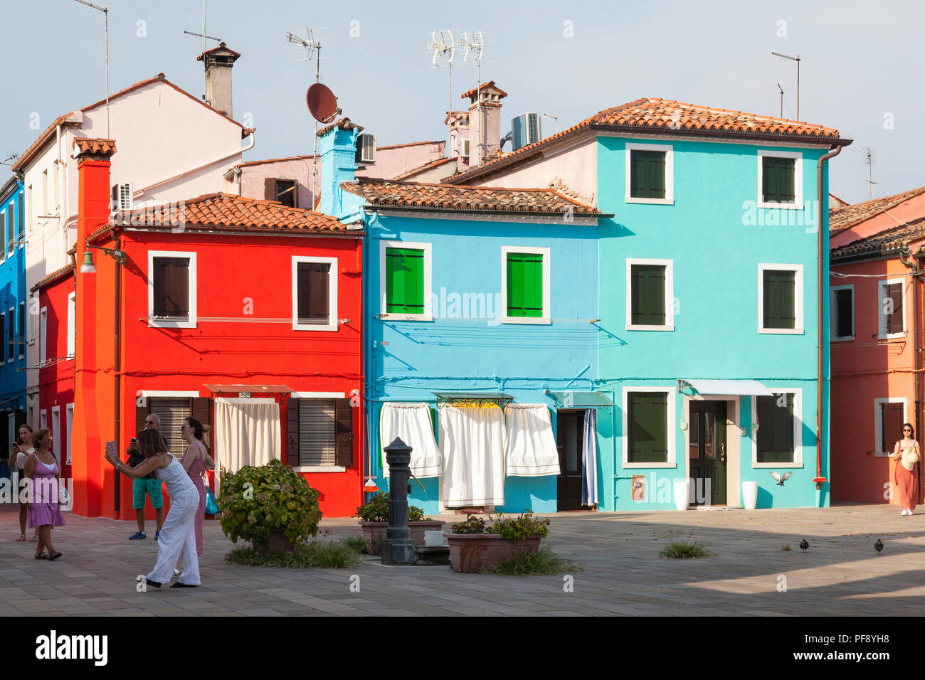 Sunset in the colourful fishing village on Burano Island, Venice, Veneto, Italy. Bright ...