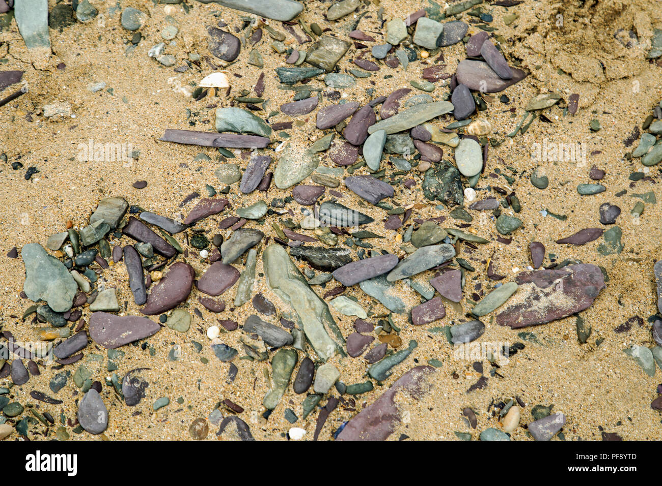 Beach scene showing rocks on a sandy beach Stock Photo - Alamy