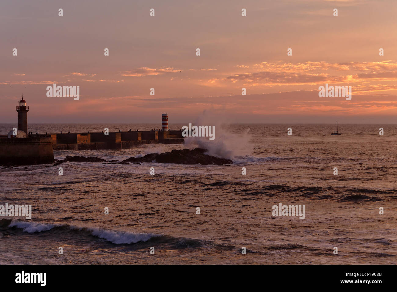Douro river mouth harbor piers and lighthouses at beautiful orange dusk ...