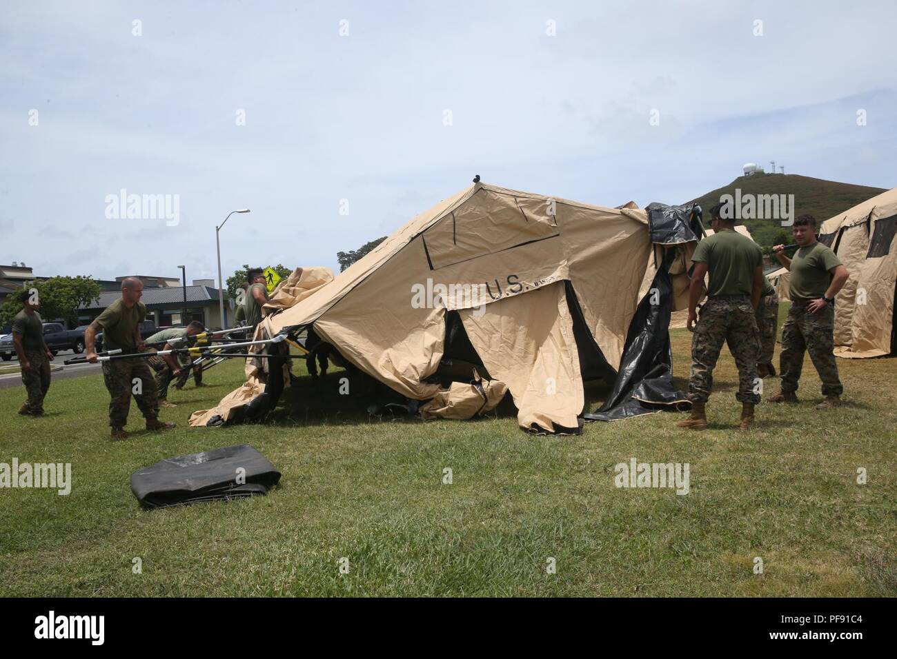 U.S. Marines with 1st Battalion, 3rd Marine Regiment, set up tents at ...