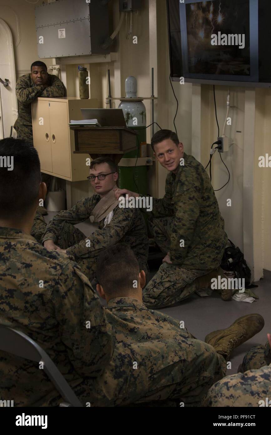 U.S. Navy Petty Officer 2nd Class Evan Ridenour (right), a corpsman ...