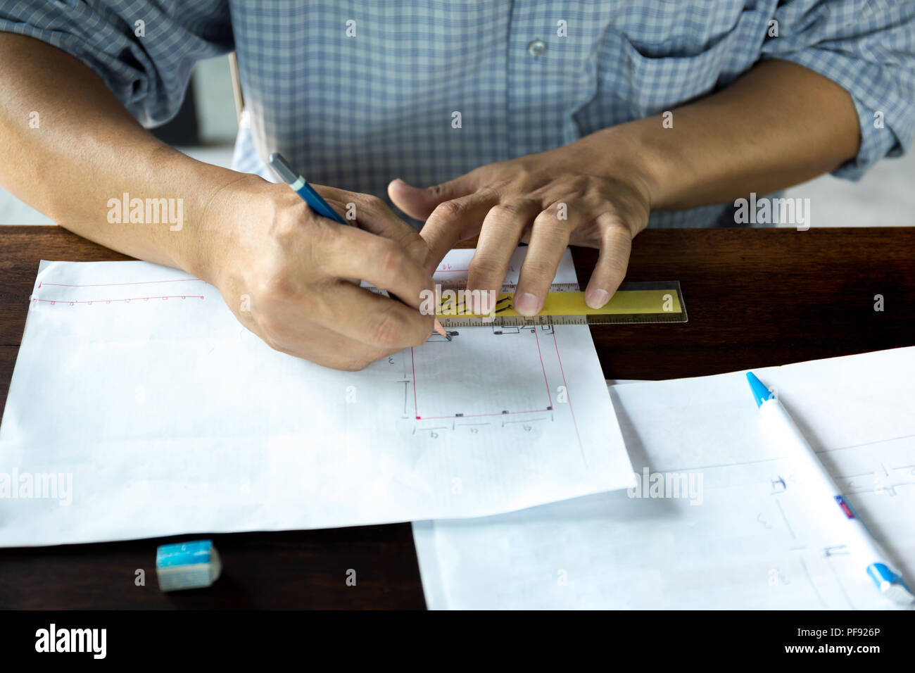 Interior designer hands drawing by pencil with computer and cell phone ...