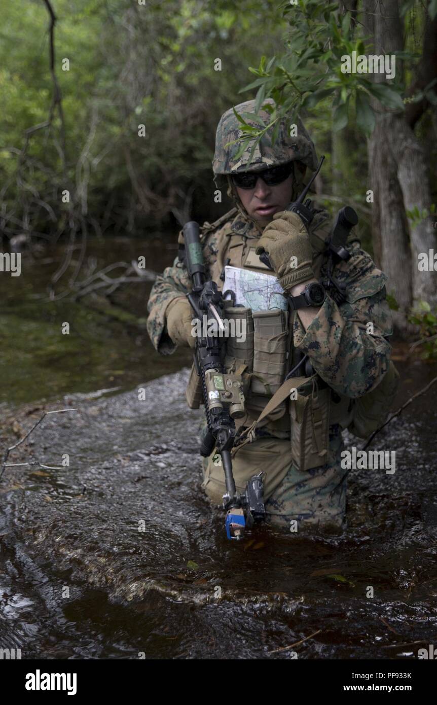 A U.S. Marine with 1st Battalion, 2nd Marines patrols through a swamp ...