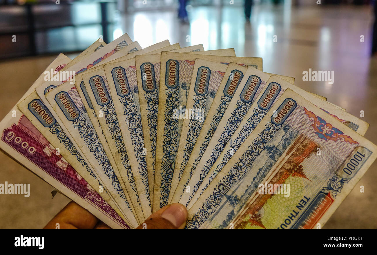 Hand holding Myanmar banknotes (MM, MMR, Kyat). Currency background ...